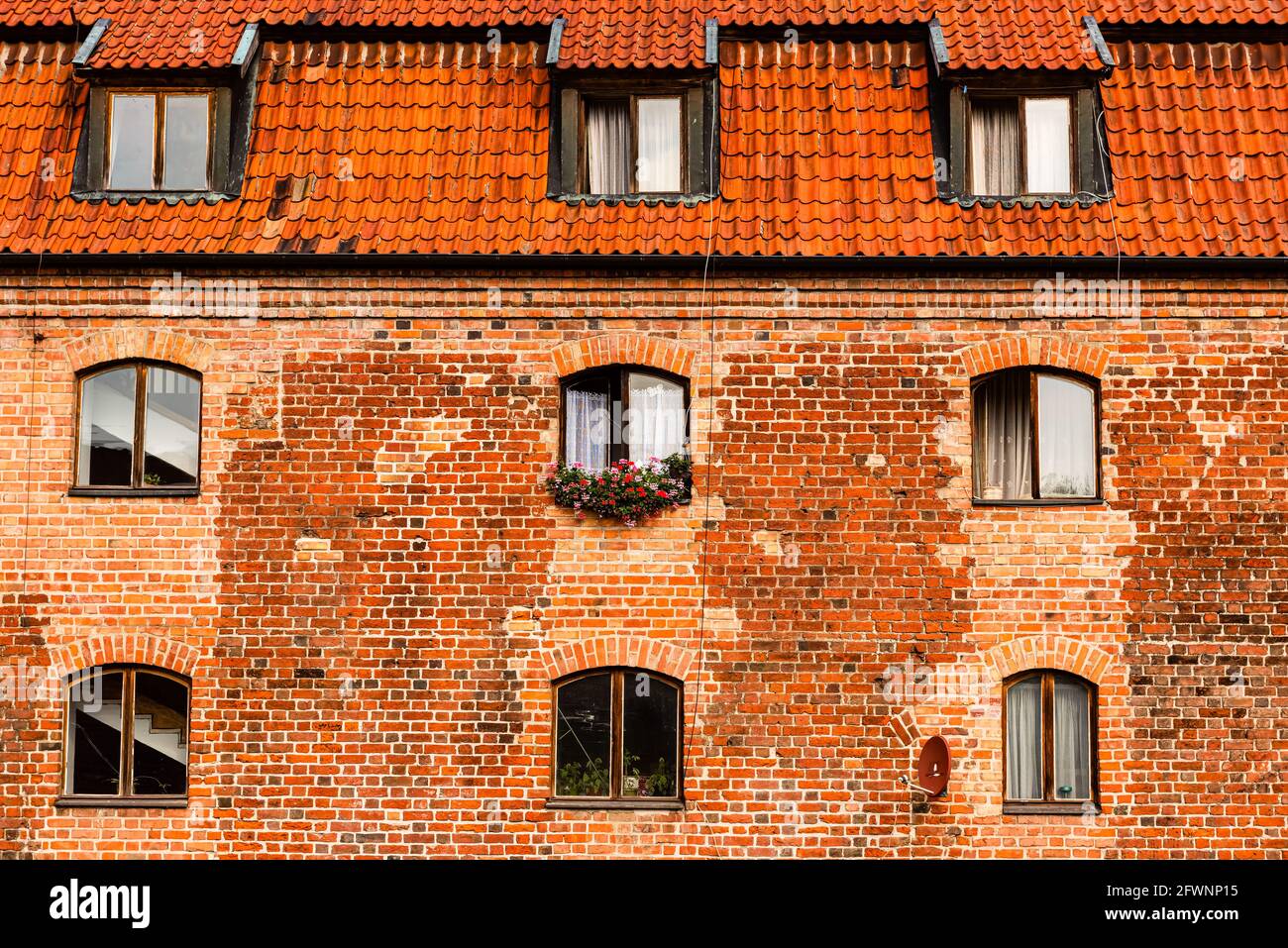 Old brick wall with small windows, facade of antique buildings Stock ...