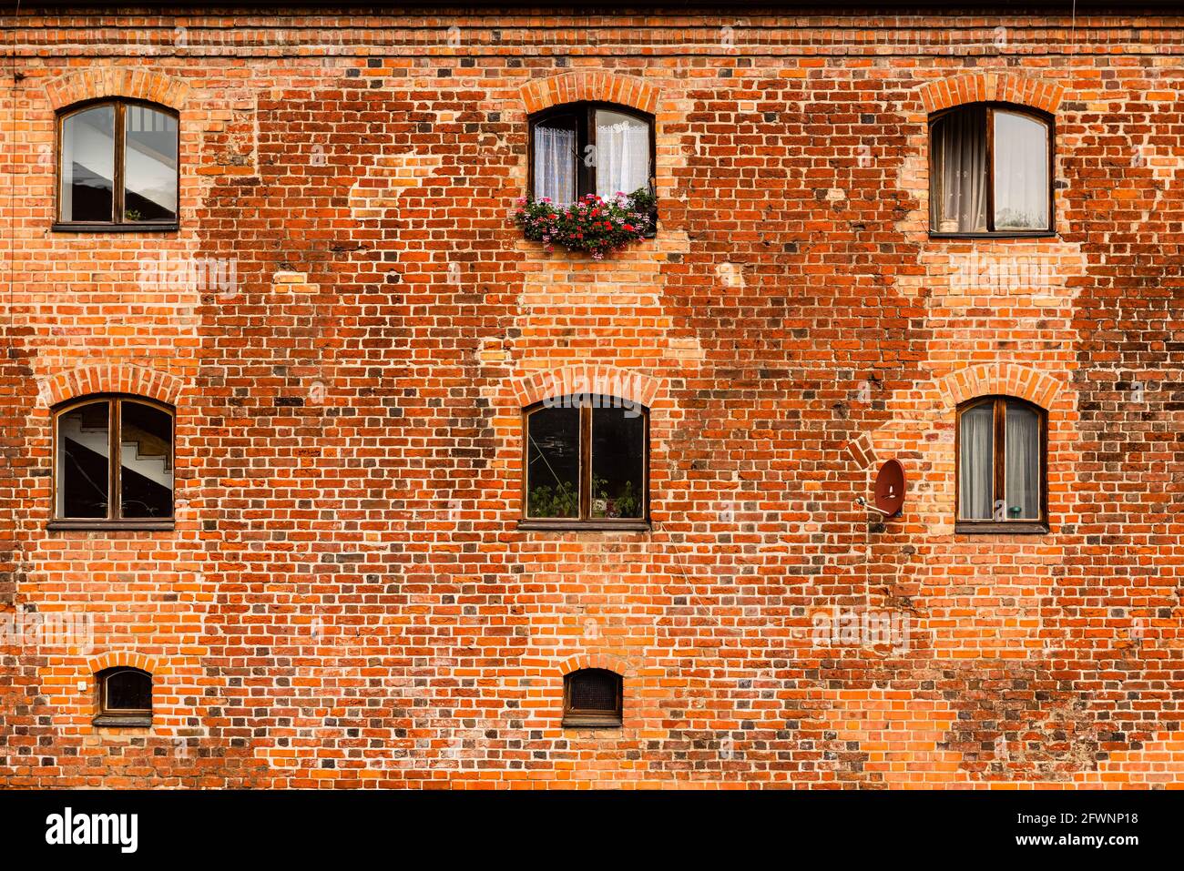 Old brick wall with small windows, facade of antique buildings Stock ...