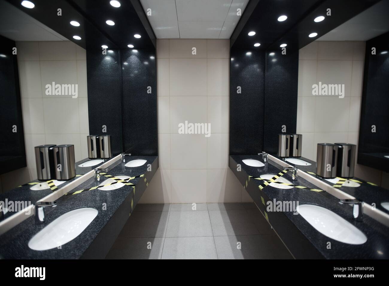 Graphic background image of public restroom interior with sinks taped ...