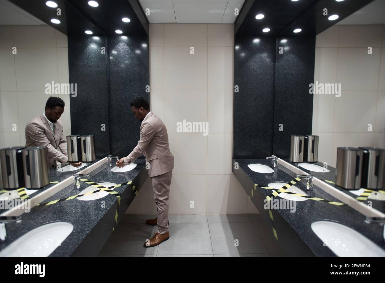 Graphic background image of African-American man washing hands in ...