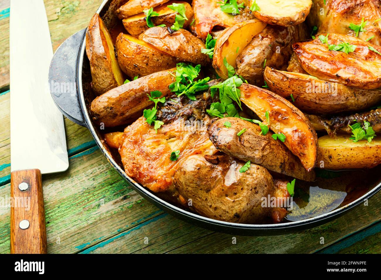 Delicious chicken meat with potatoes fried in a pan Stock Photo - Alamy