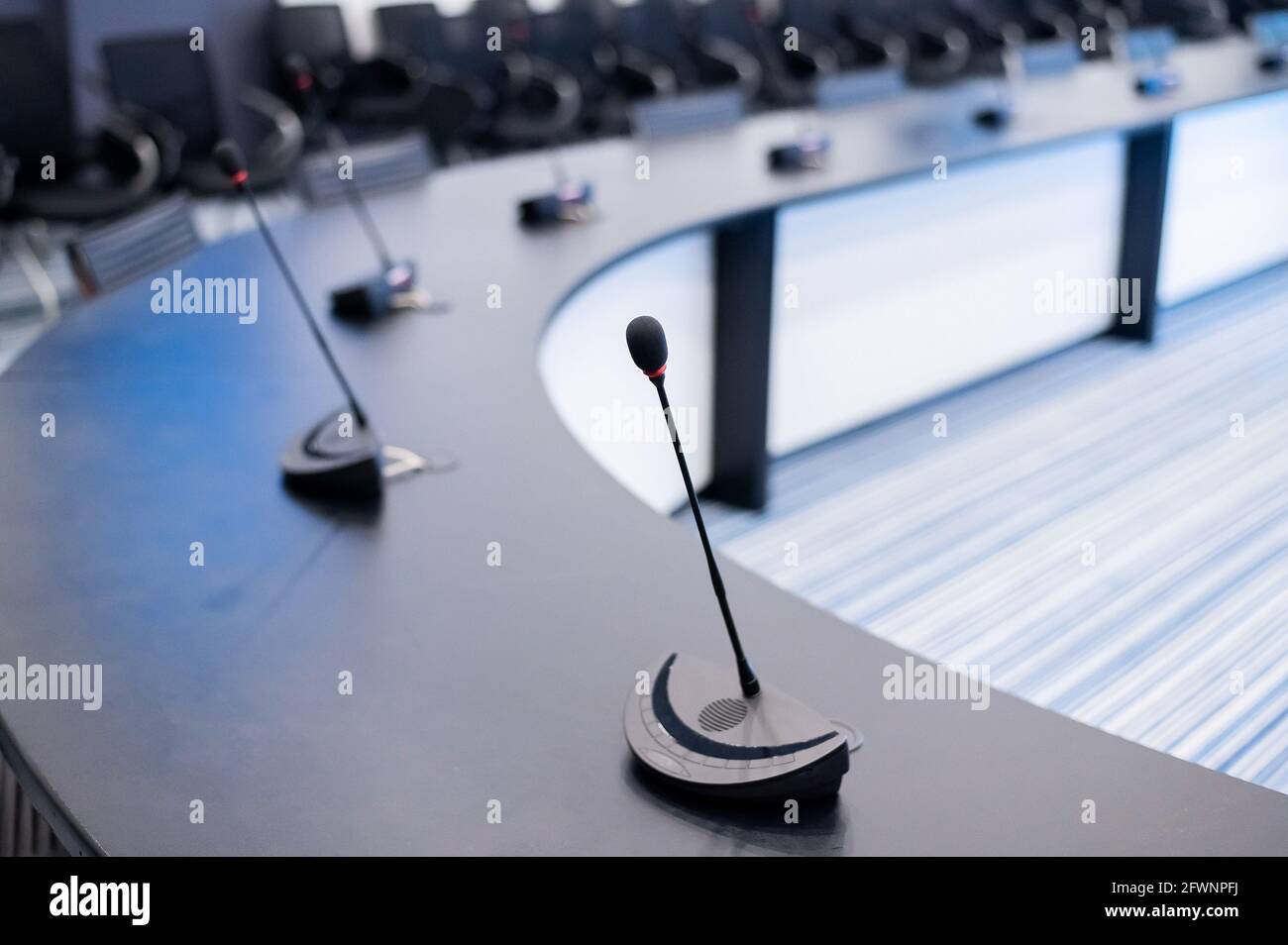 Close-up of microphones in an empty meeting room at a press conference ...