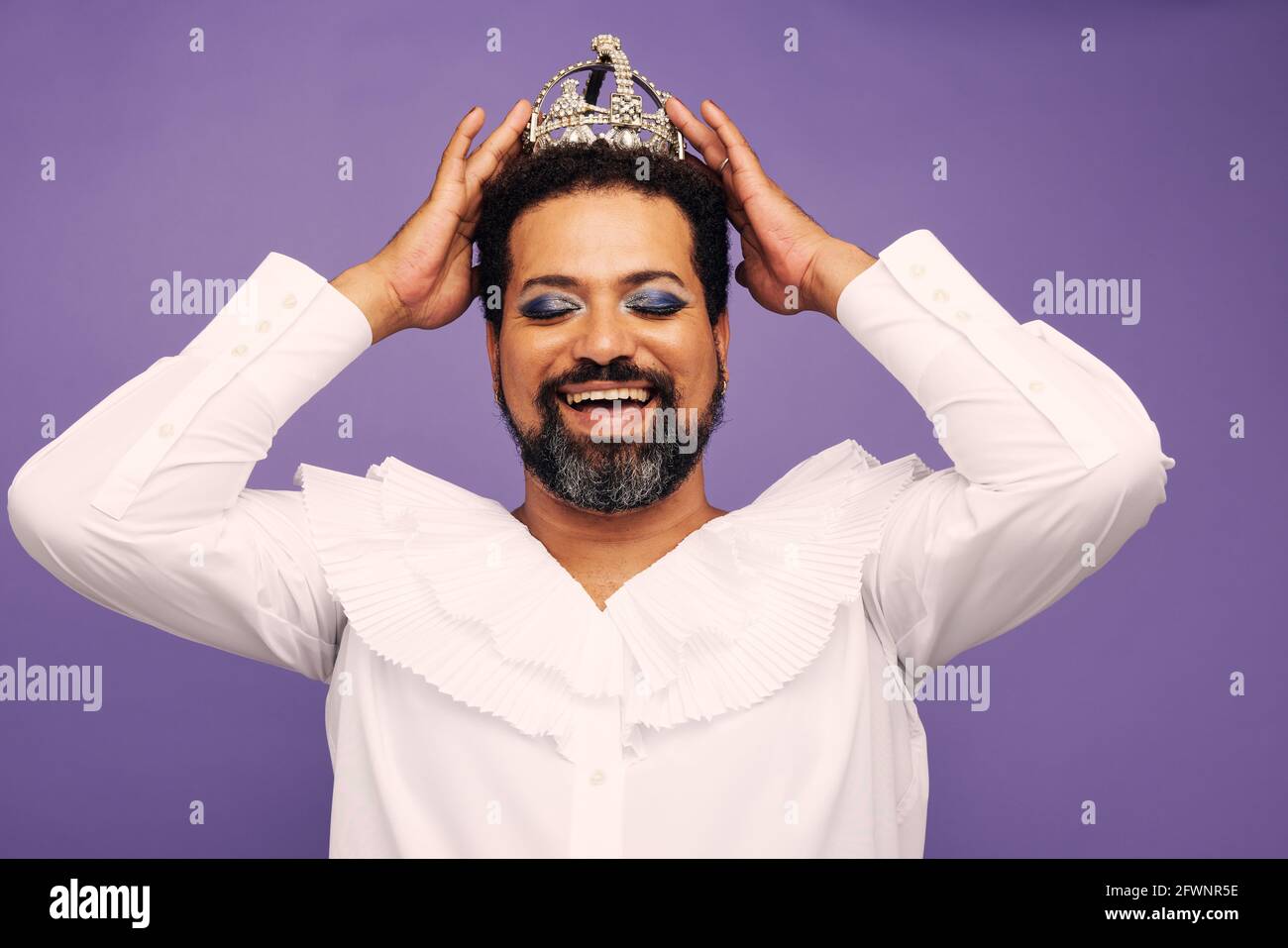 Portrait of drag queen with crown on head. Flamboyant genderqueer in ...