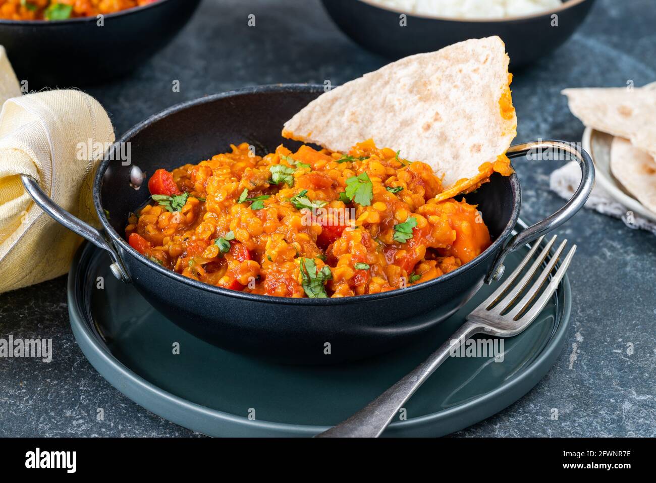 Indian vegetarian red lentil dhal curry with roti Stock Photo - Alamy