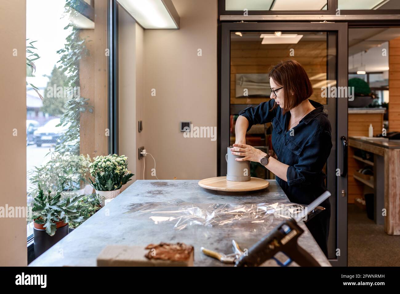 Woman florist flower bouquet in workshop. Gift concept, training ...