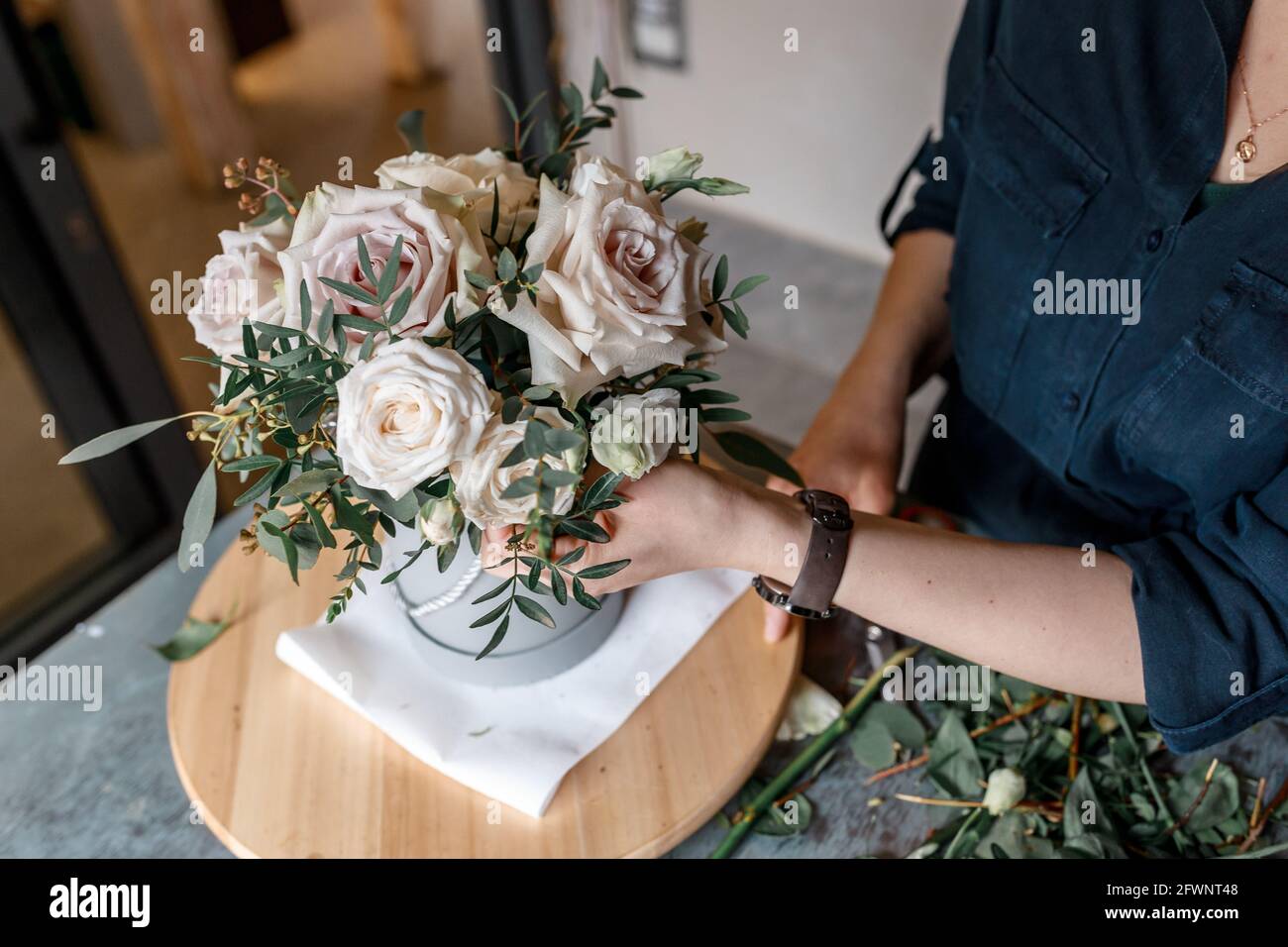 Flower arrangement of beige roses with greenery. Wedding decor and ...