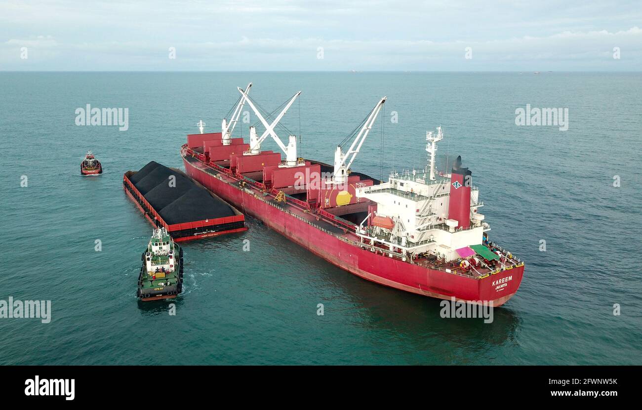 Transporting coal from the barge to the mother vessel aerial view Stock ...