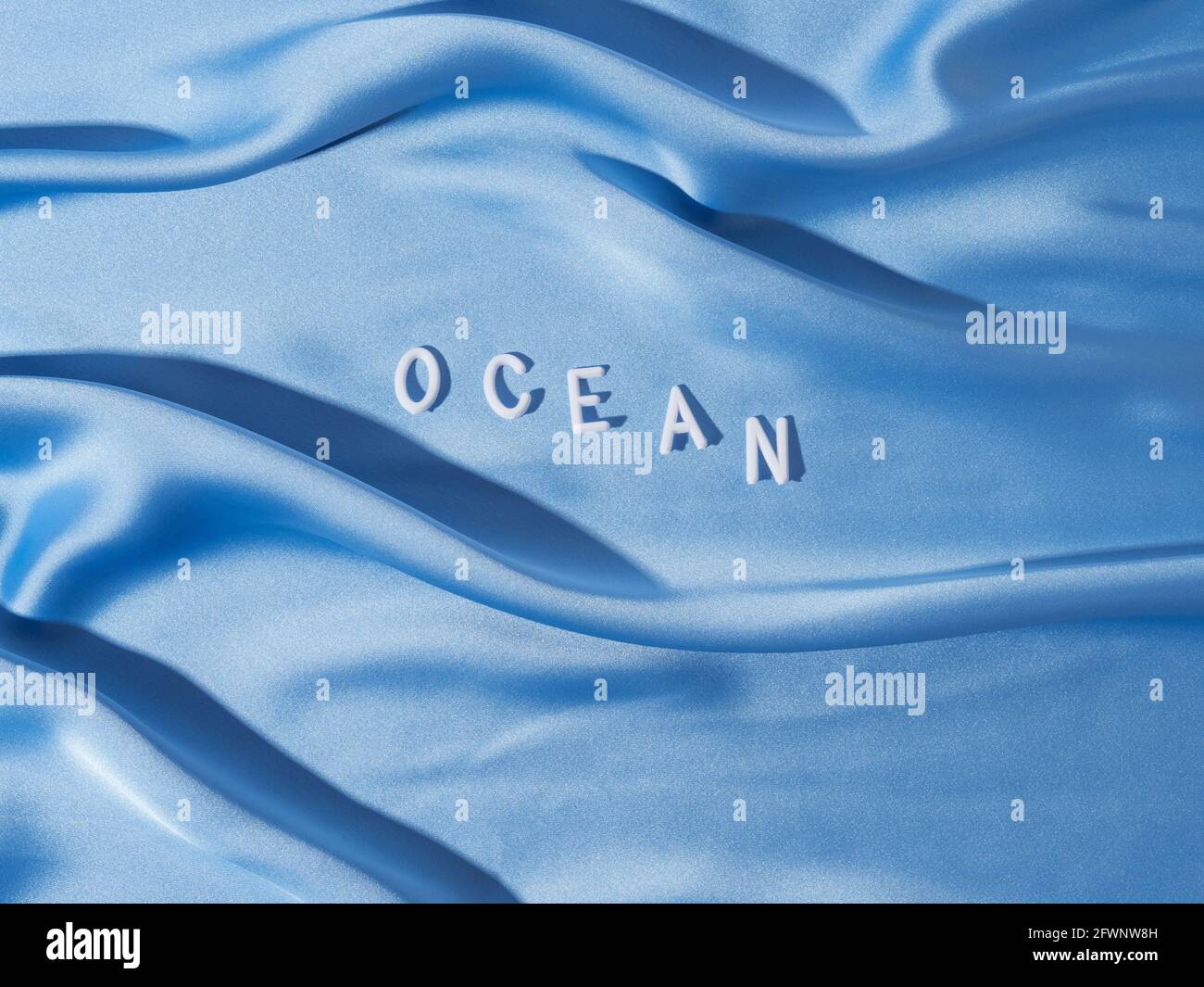 World ocean in white letters on blue wave textile Stock Photo - Alamy