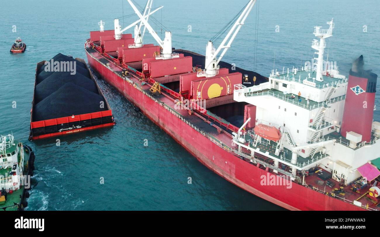 Transporting coal from the barge to the mother vessel aerial view Stock ...