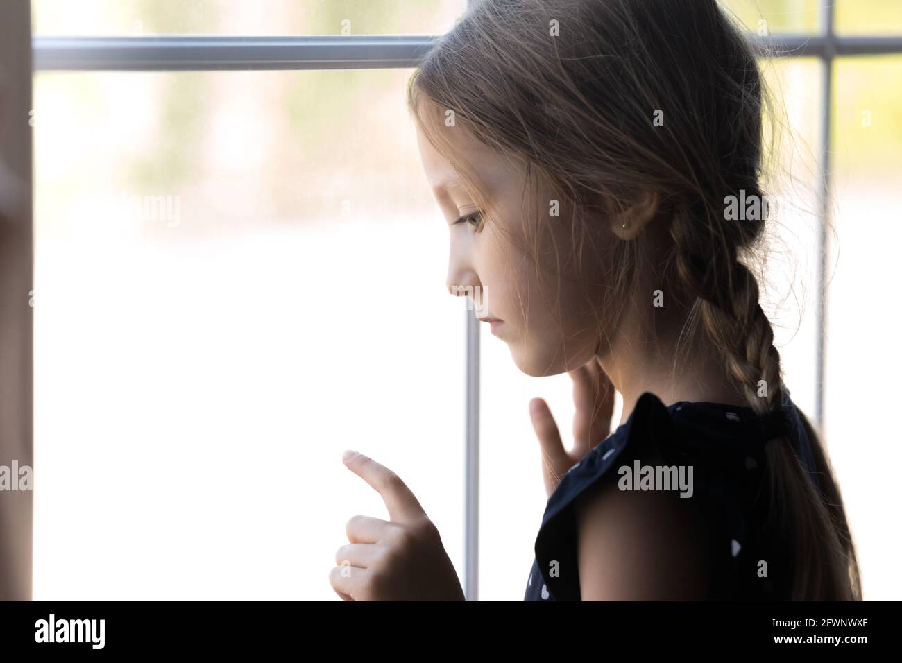 Depressed orphan kid looking out window, feeling lonely Stock Photo - Alamy