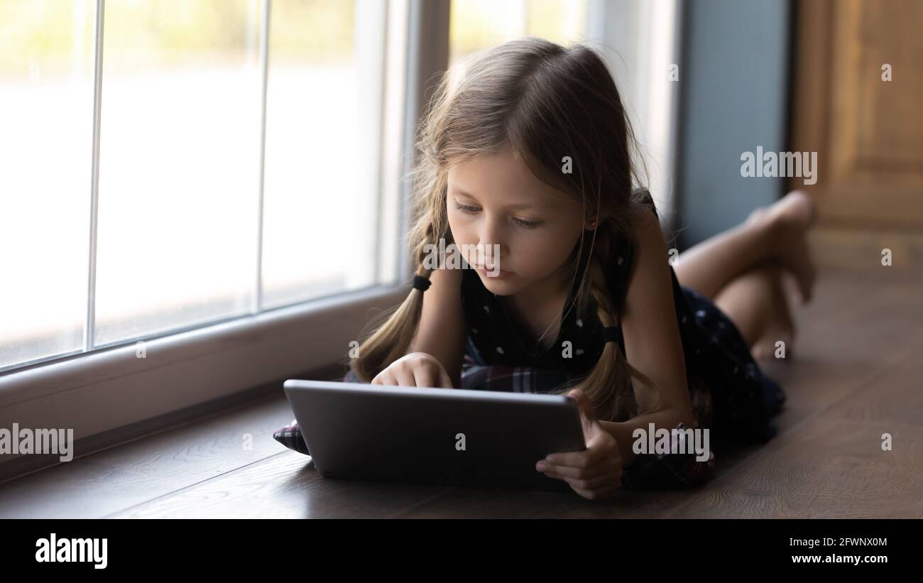 Focused pre teen school kid doing home task online Stock Photo - Alamy
