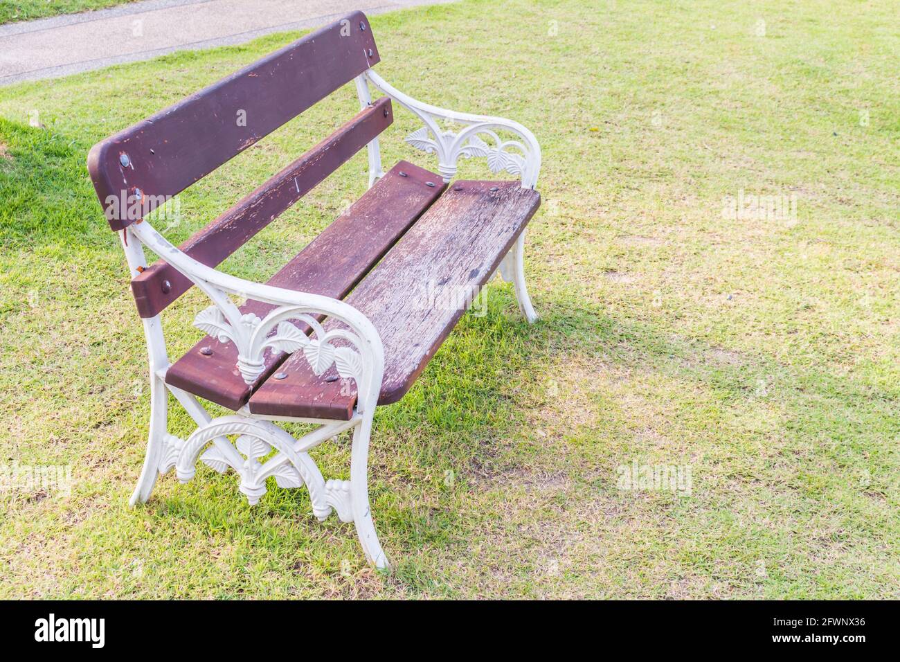 White chair in the park on green grass background Stock Photo - Alamy