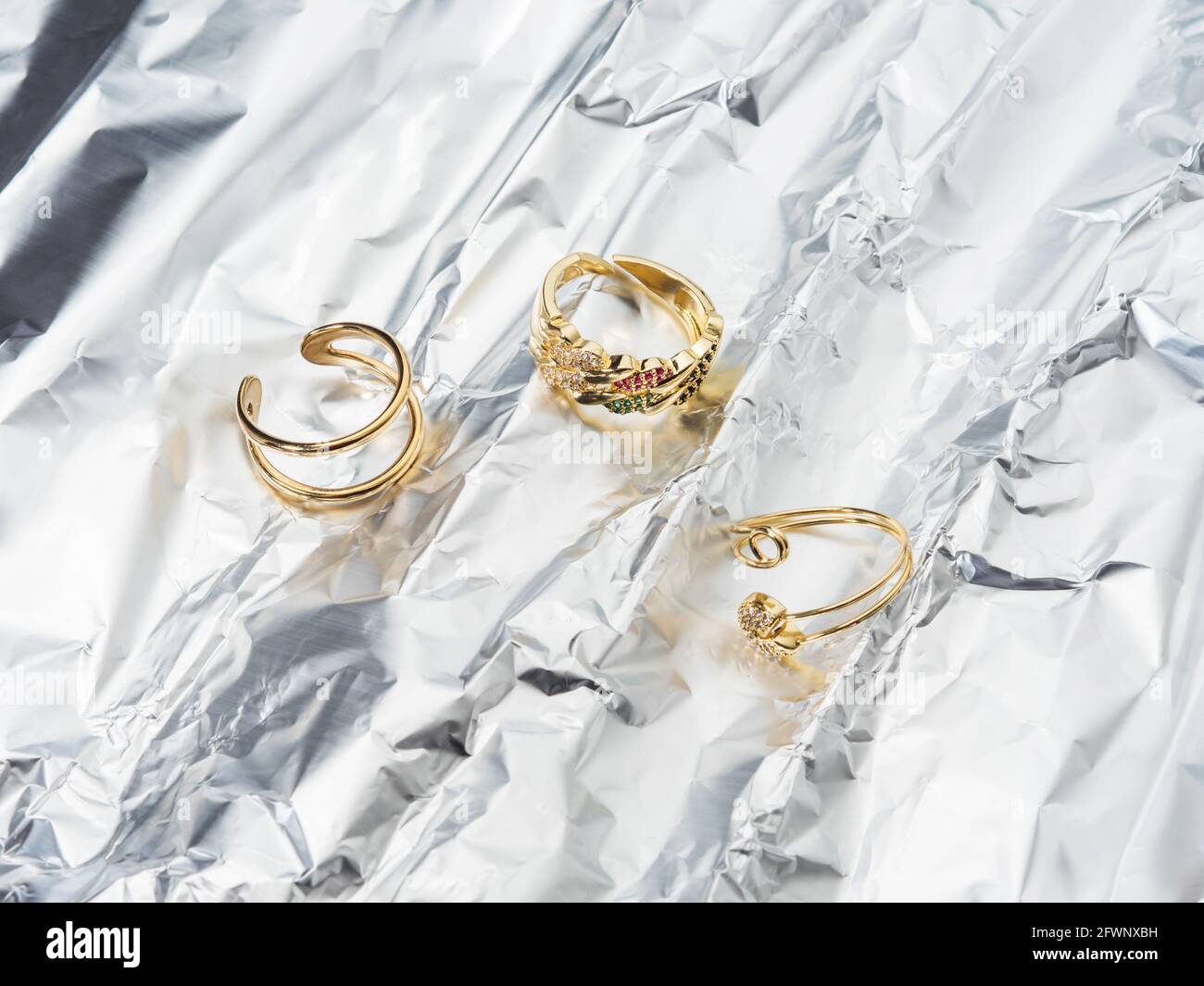 Golden jewelry ring accessories on silver metallic background Stock ...