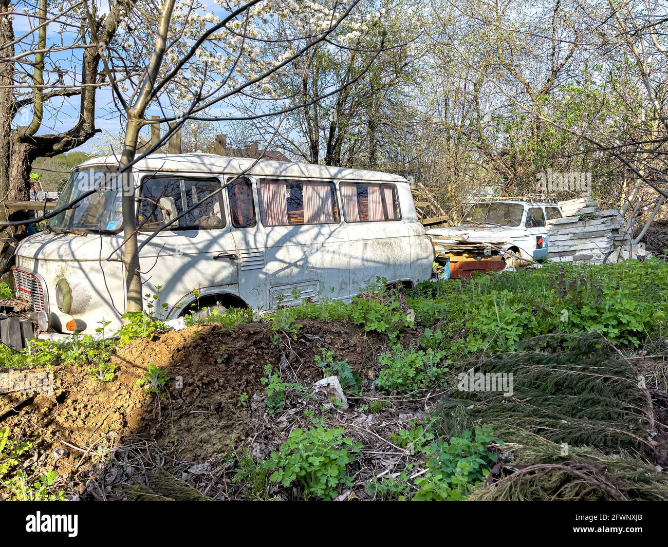 An old broken bus in a car dump among the rubbish Stock Photo - Alamy