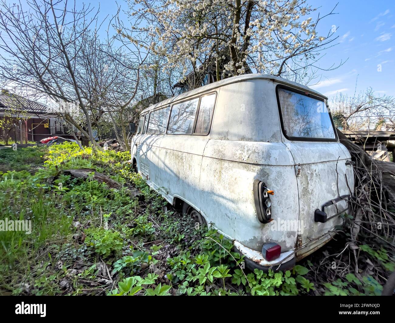 An old broken bus in a car dump among the rubbish Stock Photo - Alamy