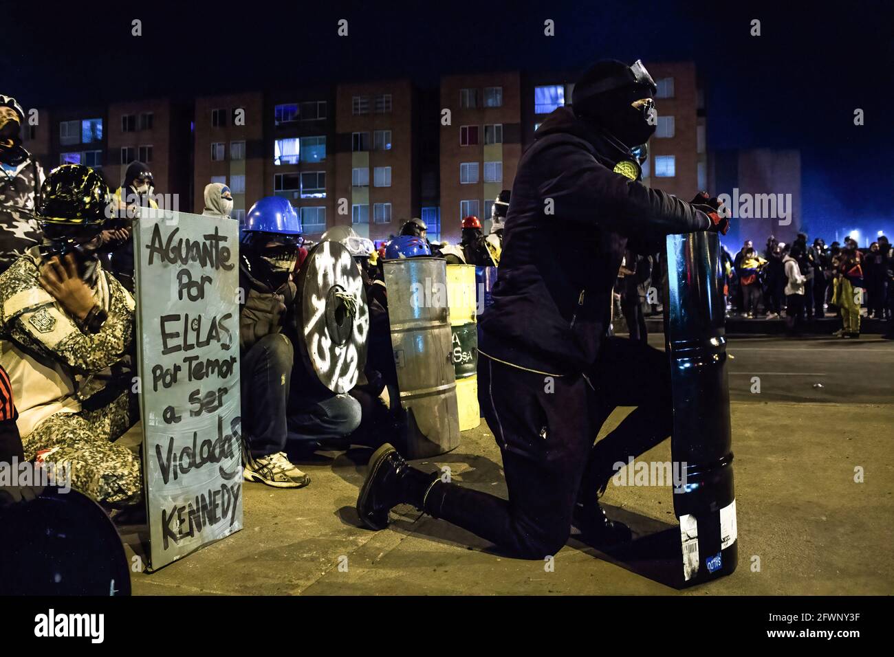 A group of protesters from the first line take cover behind their ...