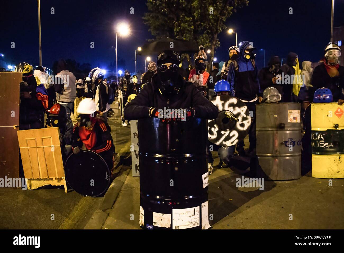 A group of protesters from the first line stand behind their homemade ...