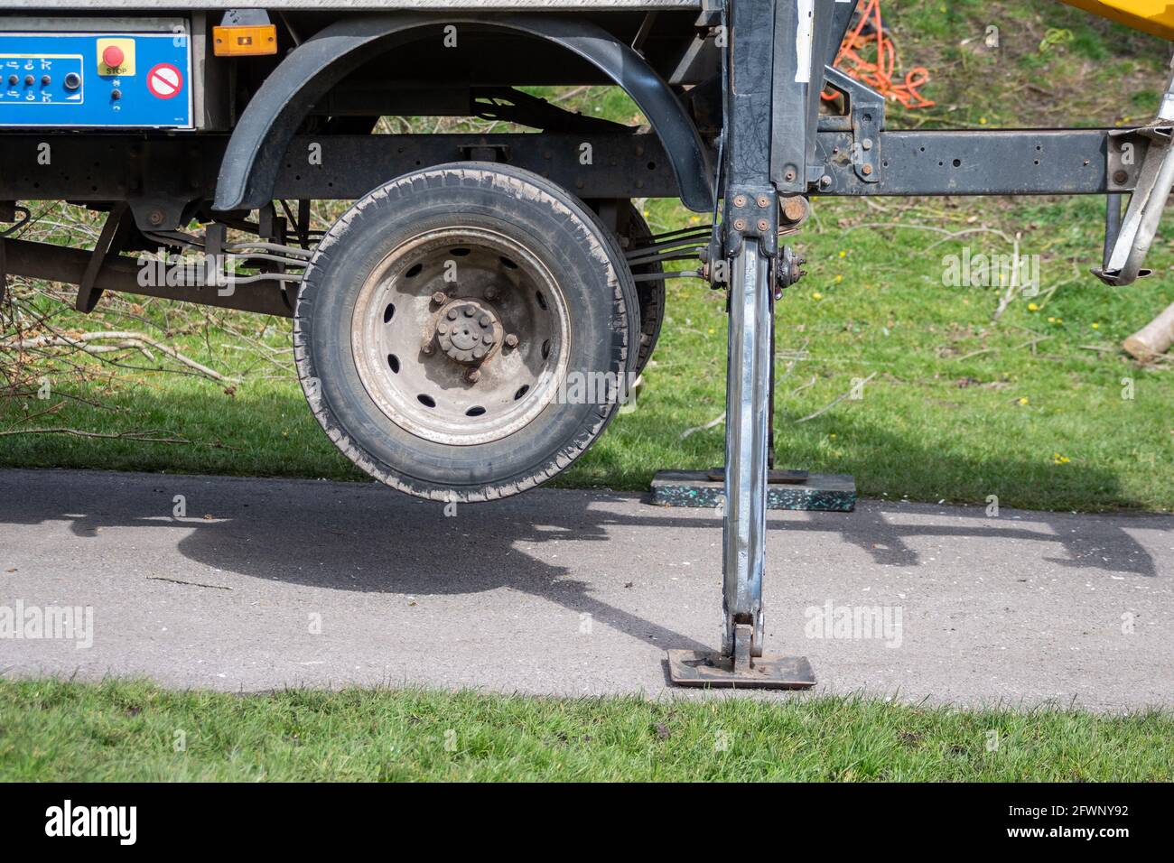 Close view of the rear wheels of a cherry picker truck raised off the ...