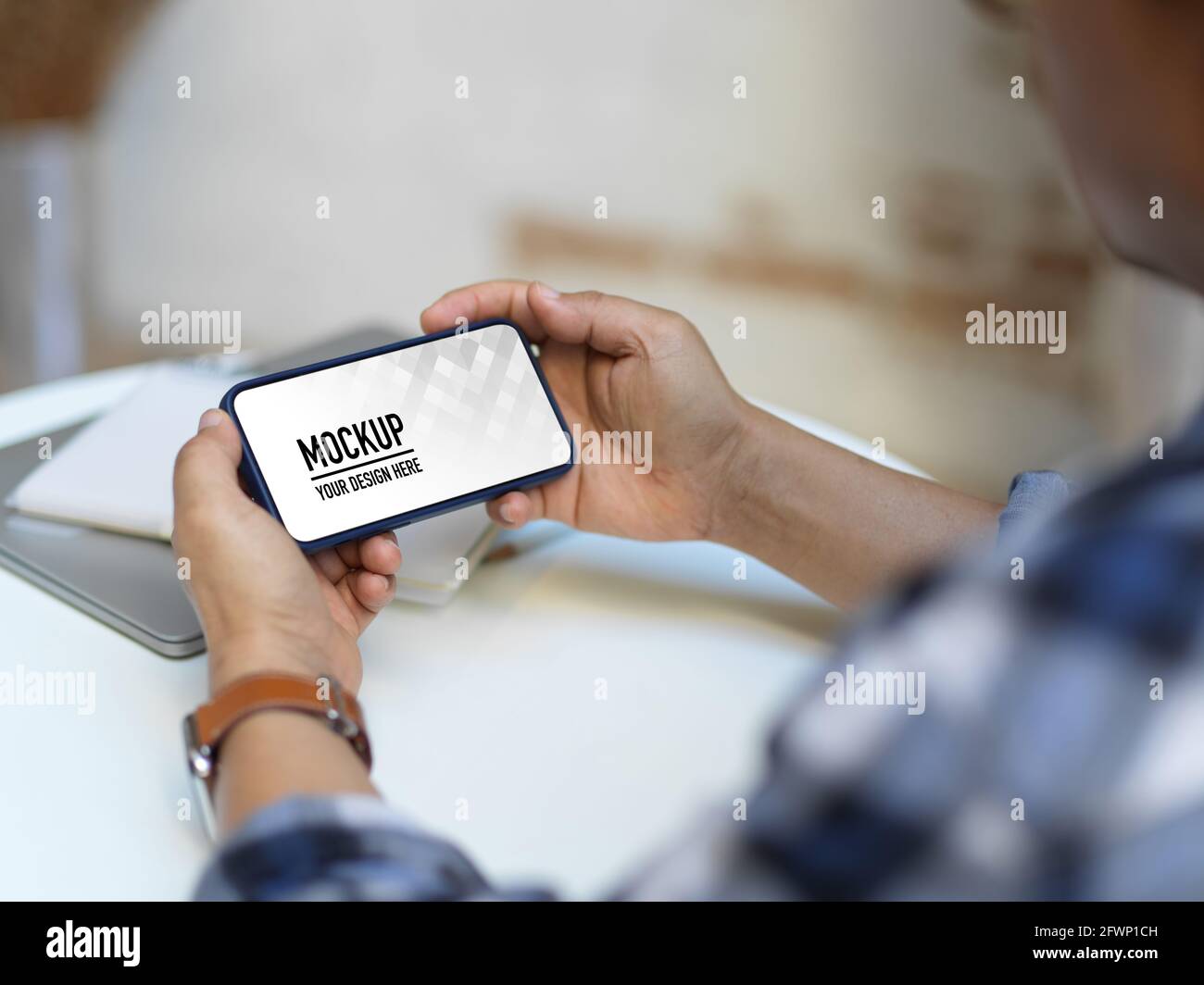Close up view of male hands using horizontal smartphone while sitting ...