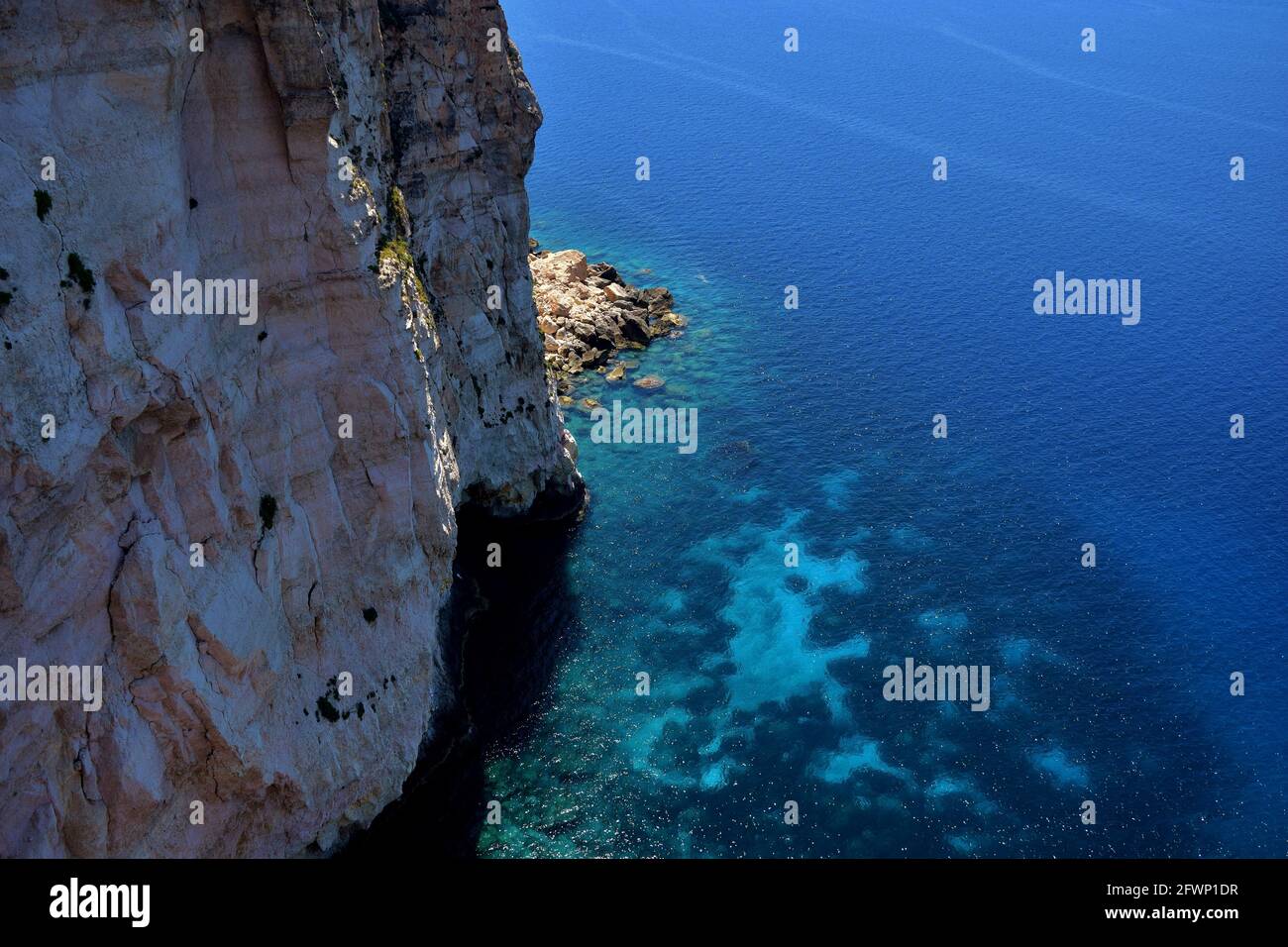 High angle shot of coastal cliff and erosion boulder in Maltese Islands ...