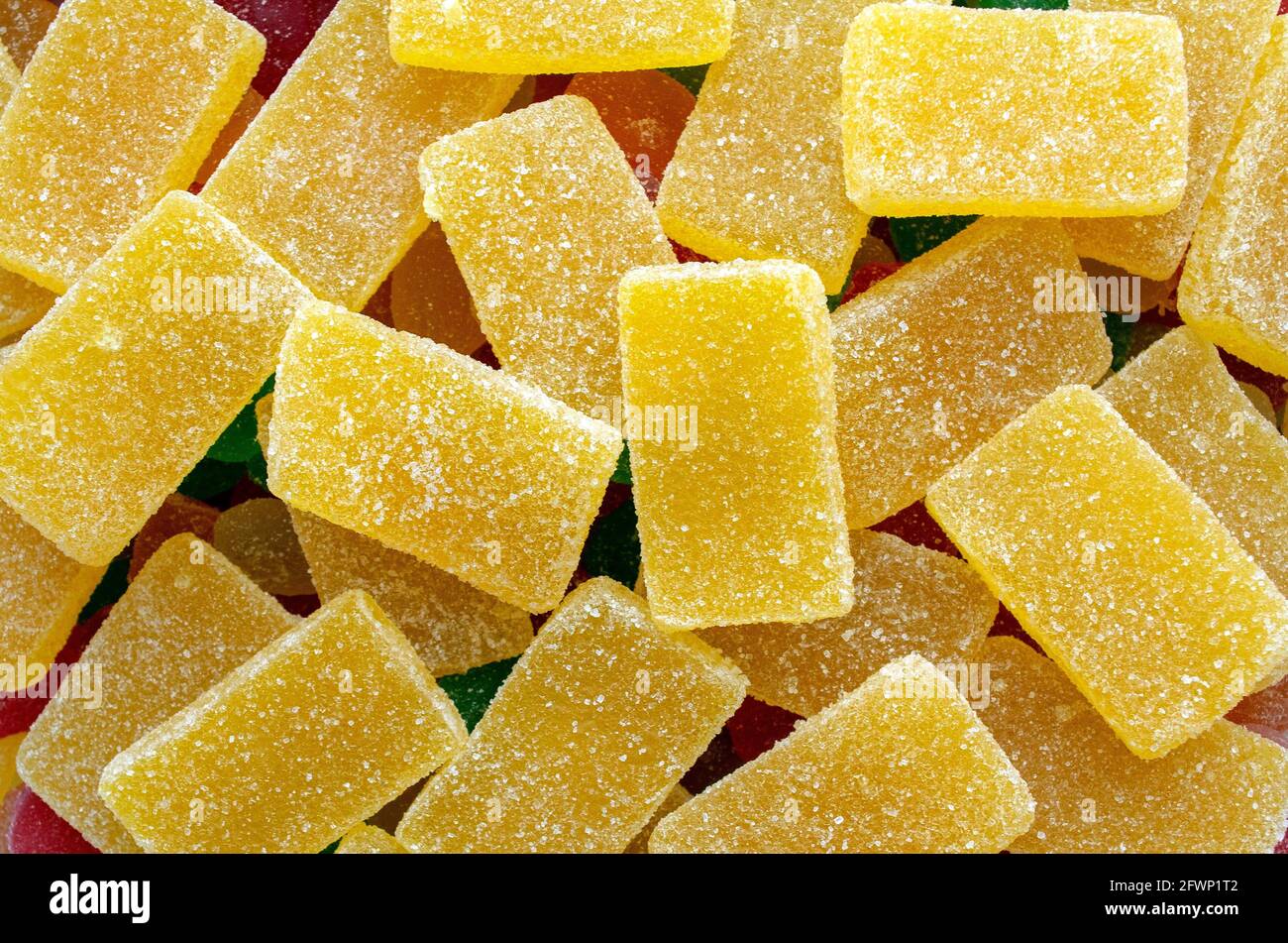 Yellow rectangular jelly candies pattern background. Yellow rectangular ...
