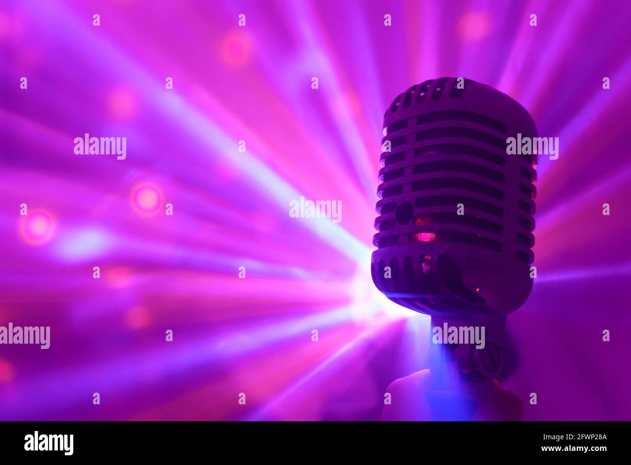 Singer holding retro microphone. Live performance or karaoke concept ...