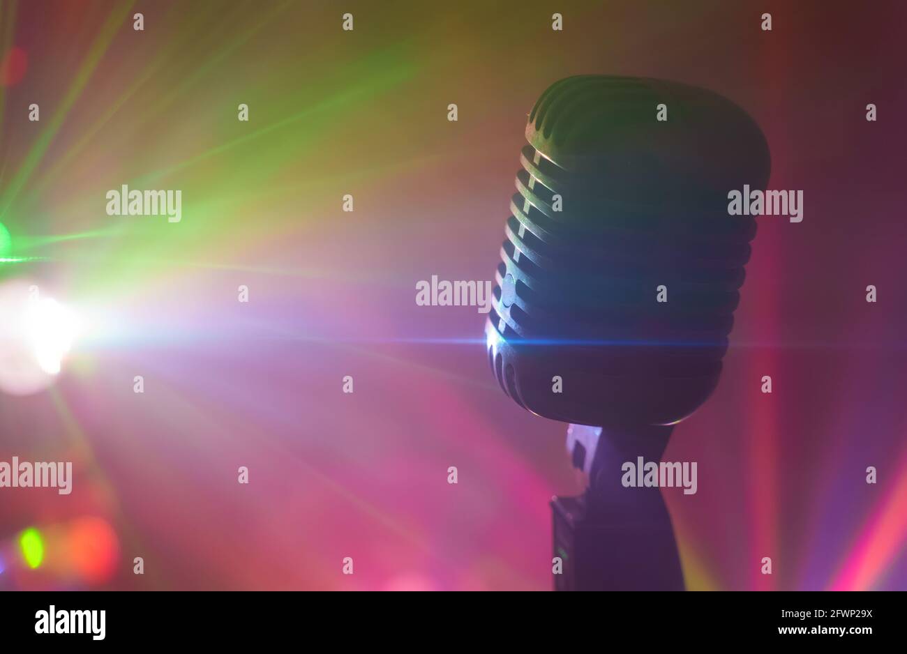 Vintage microphone with stage disco lights. Live performance or karaoke ...