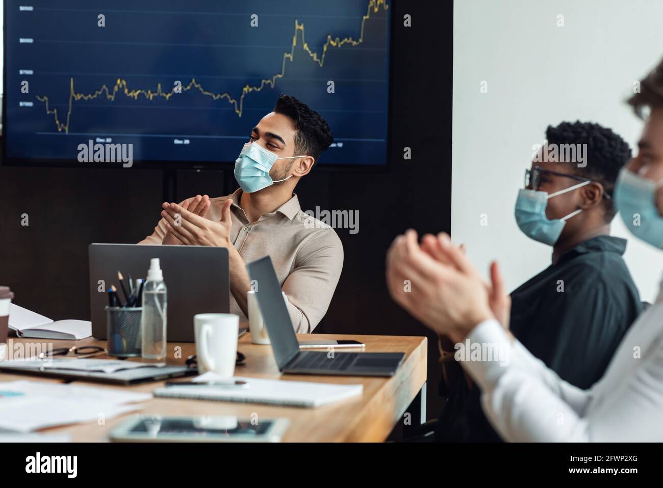 Colleagues having meeting in boardroom, clapping hands Stock Photo - Alamy