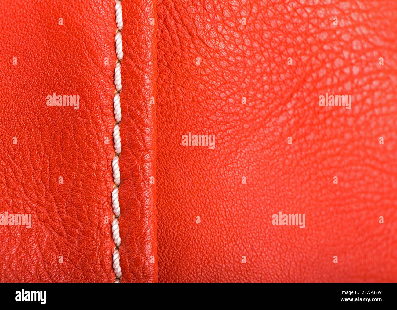 leather texture, orange background skin stitched with white thread ...