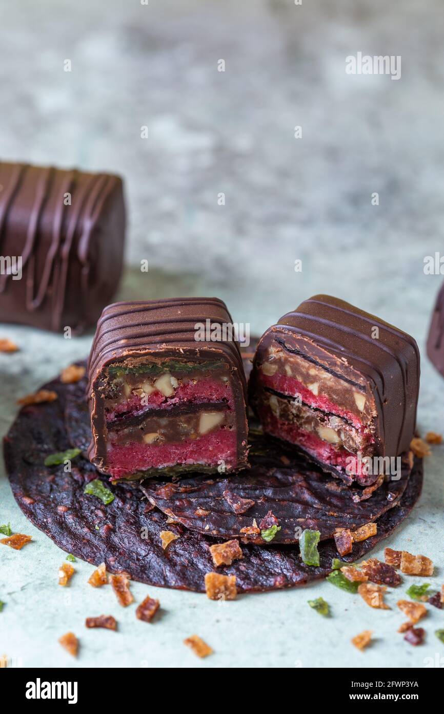Vertical shot of raw chocolate cookies with nuts on the table with a ...