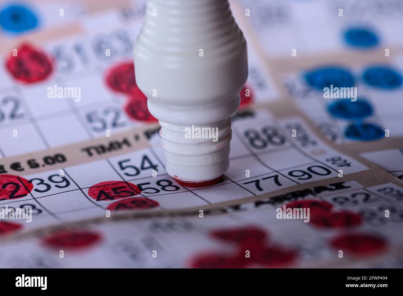 Playing Bingo. Marking numbers with red marker Stock Photo - Alamy