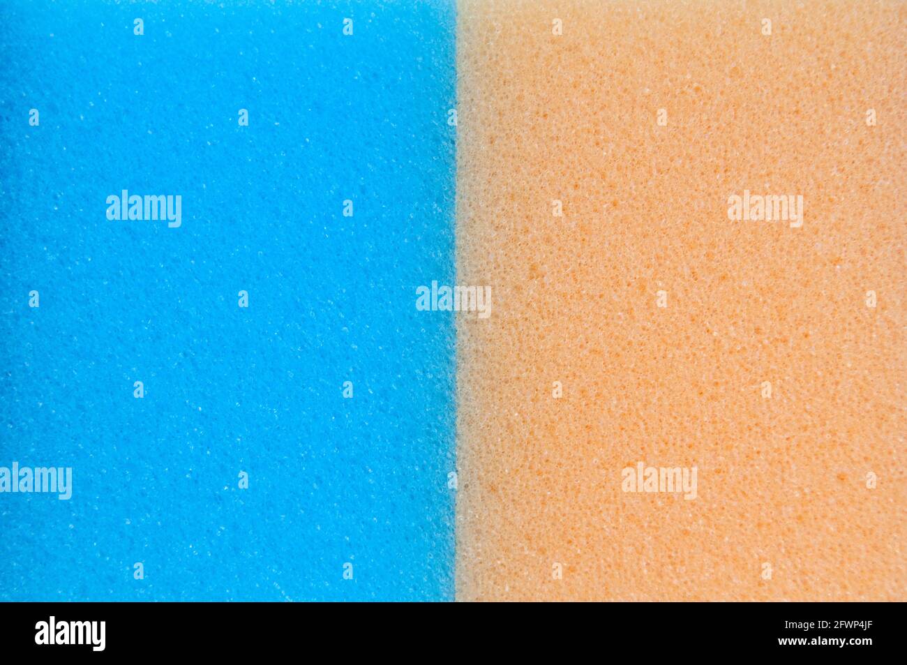 A Close Up Shot Of Two Washing Up Sponges, One Blue and One Orange ...