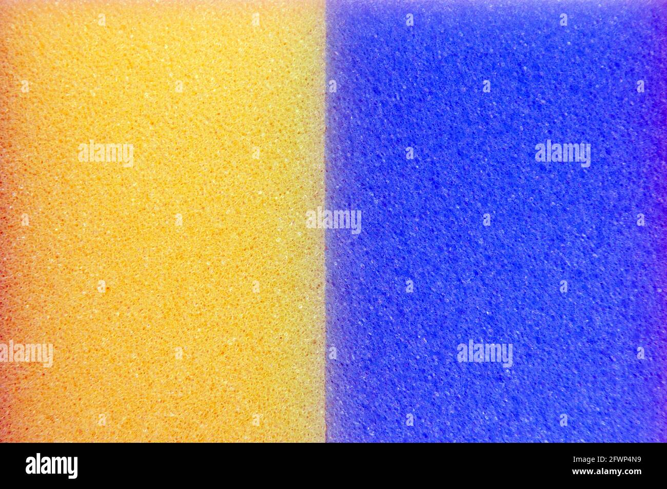 A Close Up Shot Of Two Washing Up Sponges, One Yellow and One Blue ...