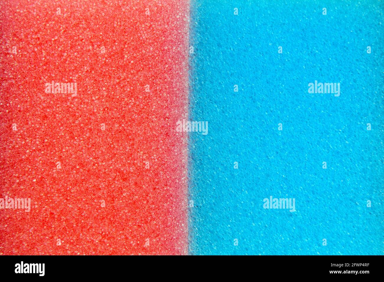 A Close Up Shot Of Two Washing Up Sponges, One Orange and One Blue ...