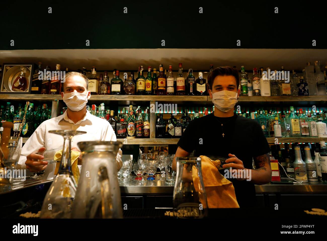 Palma, Spain. 23rd May, 2021. Leandro (L) and Oscar, waiters of the bar ...