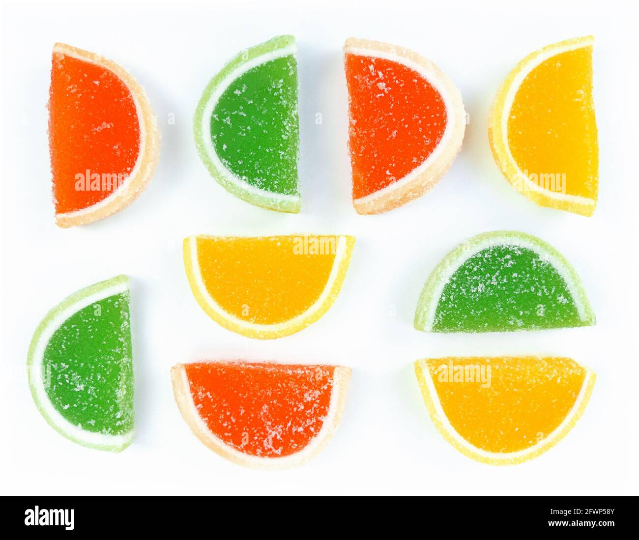 Multicolored marmalade citrus slices in sugar on white background Stock ...