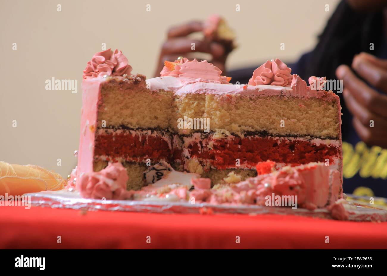 KAMPALA, UGANDA - Apr 20, 2021: Sliced birthday and party cake with ...