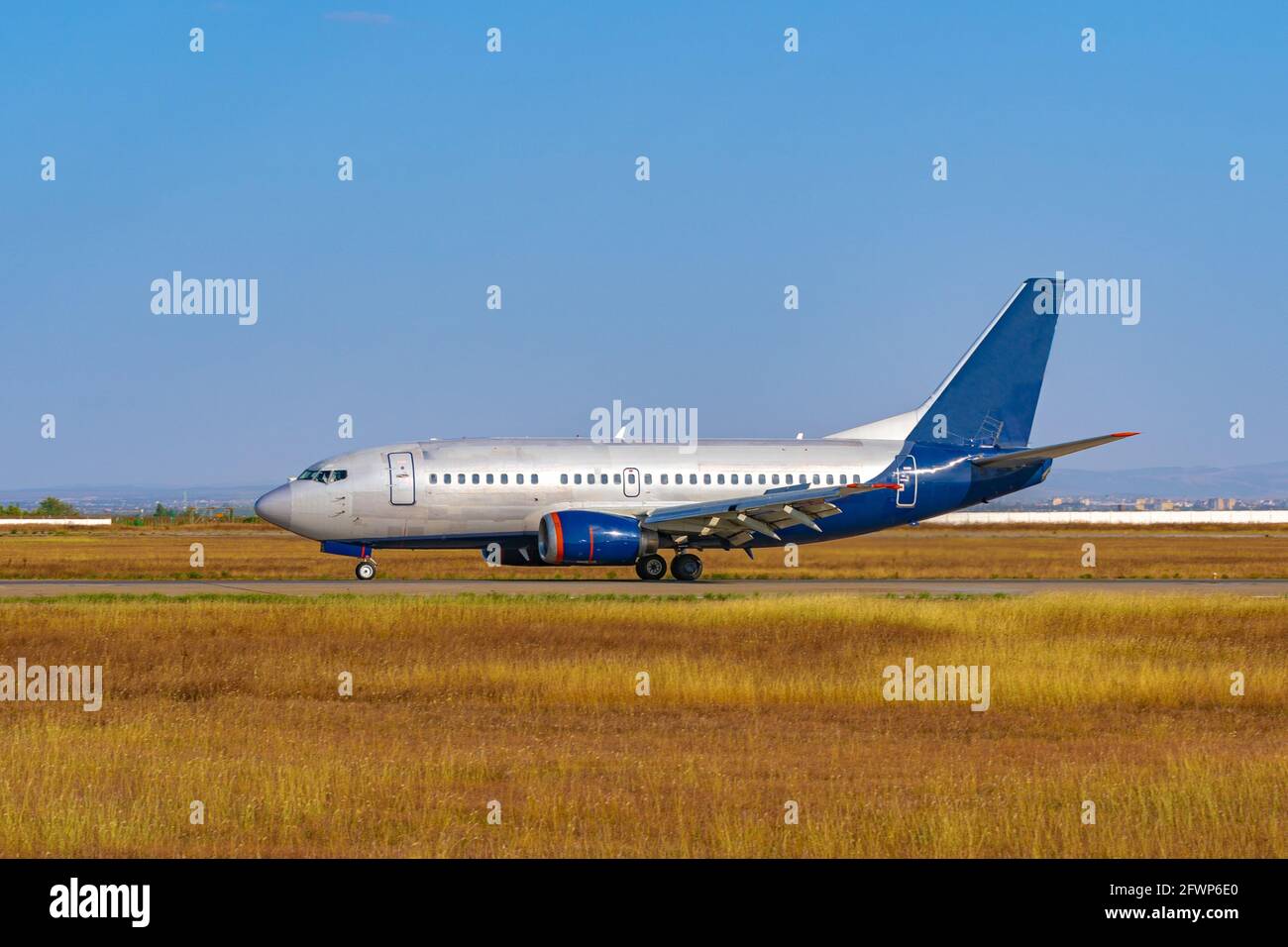 Big passenger airplane drives along the runway in airport Stock Photo ...