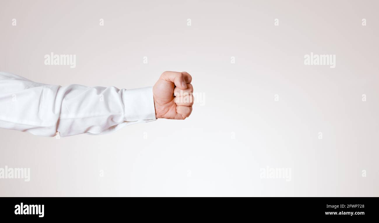 Businessman arm with hand as a clenched fist on white background with ...