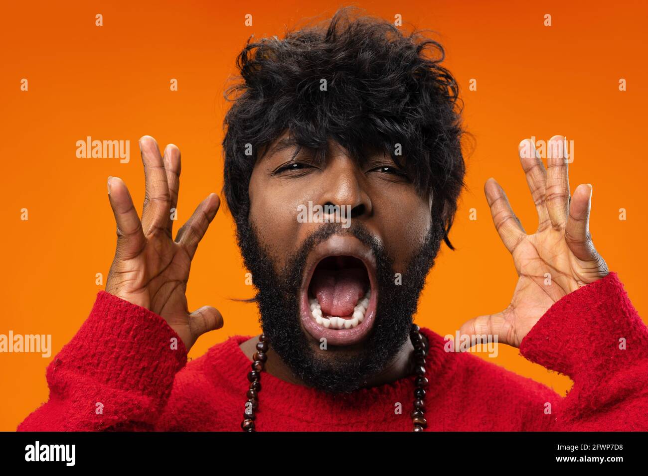Young thrilled casual black man screaming on yellow background Stock ...