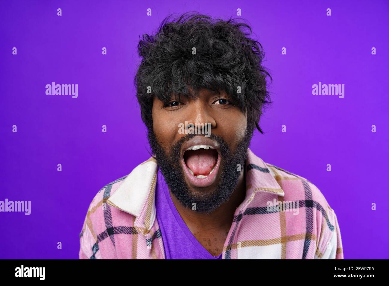 Young thrilled black man screaming on purple background Stock Photo - Alamy