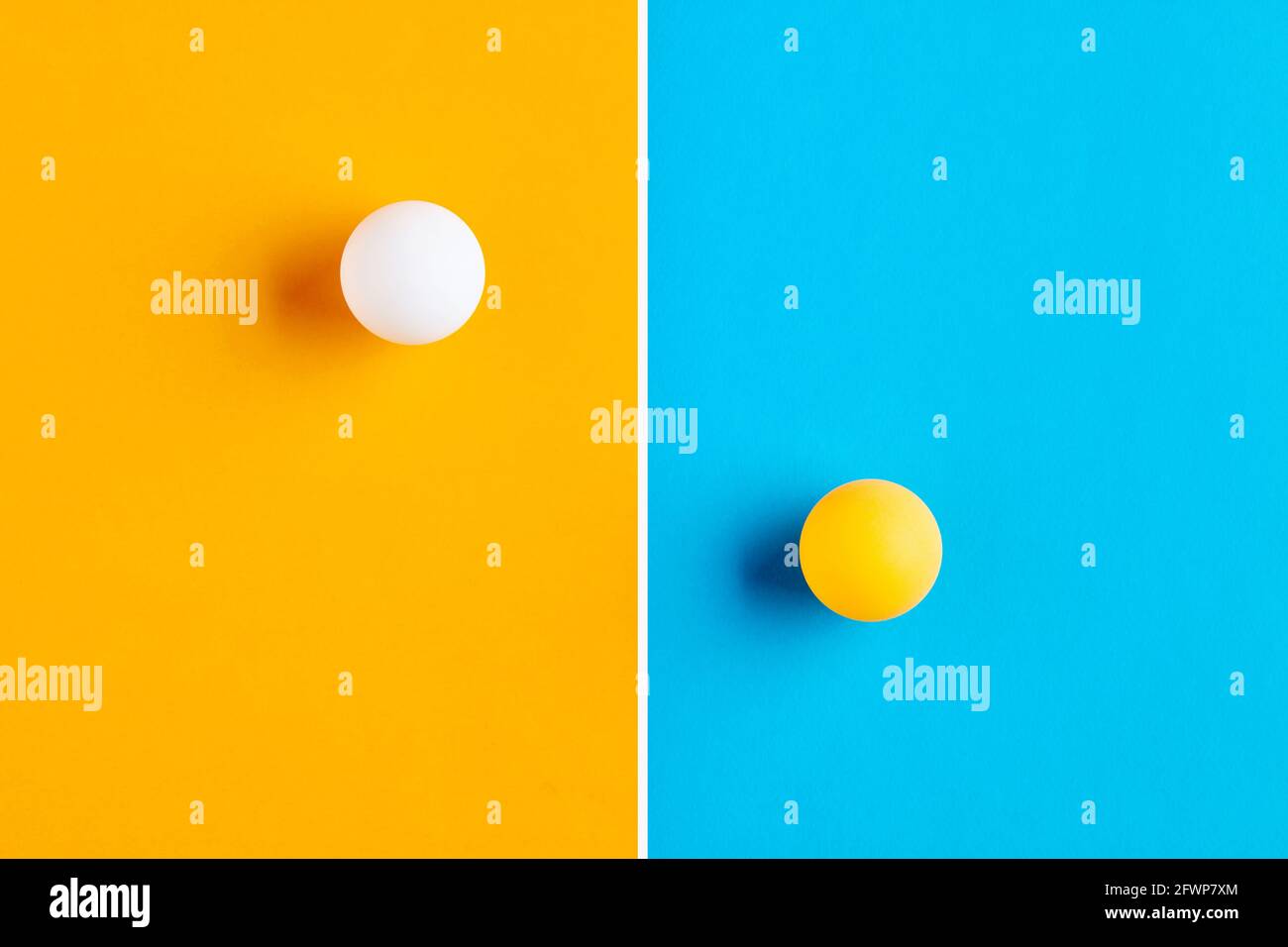 Table tennis balls in contrast. Competition, diversity, opposition or ...