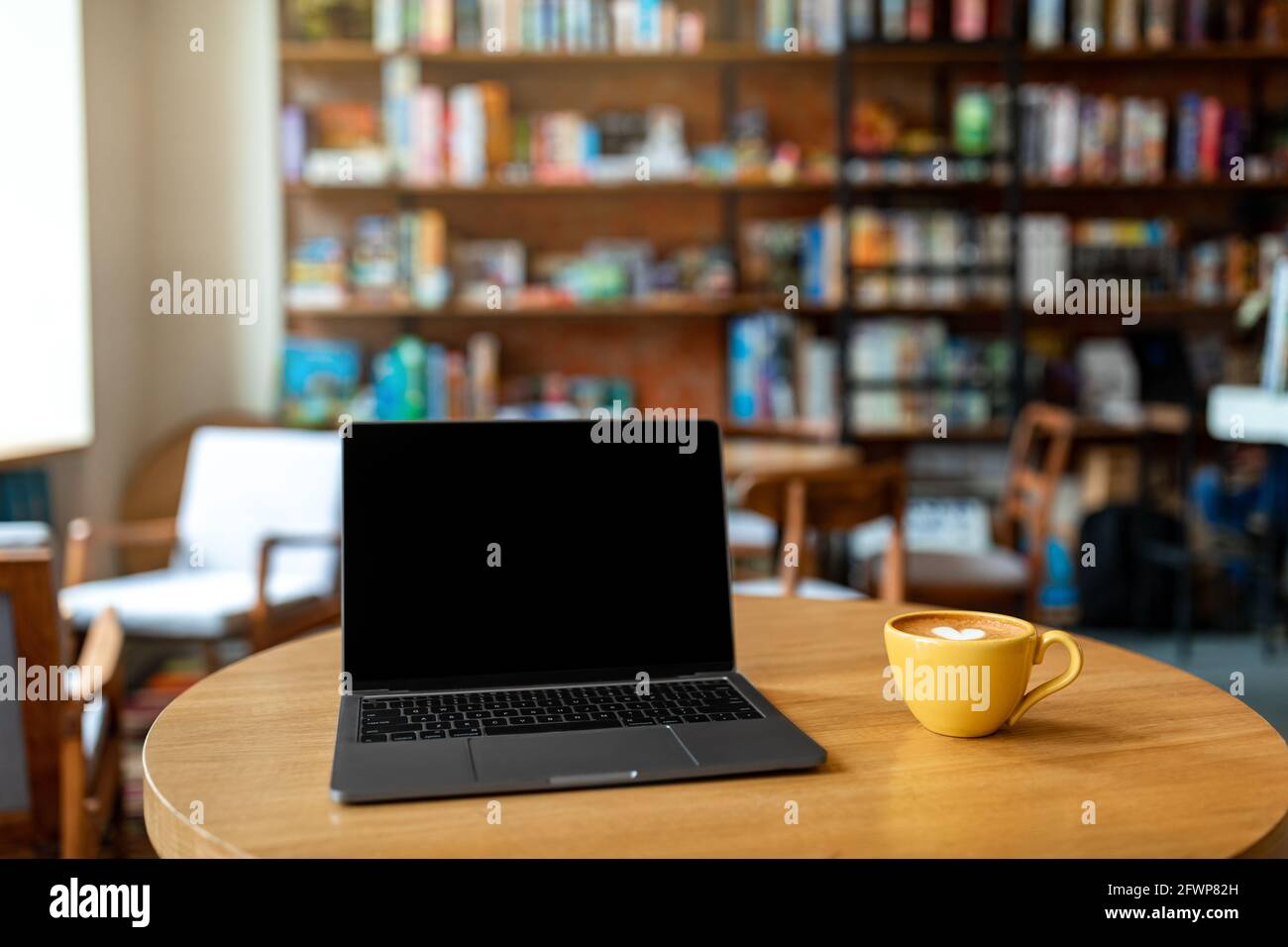 Workplace in cafe. Laptop computer with black blank screen and mug of ...