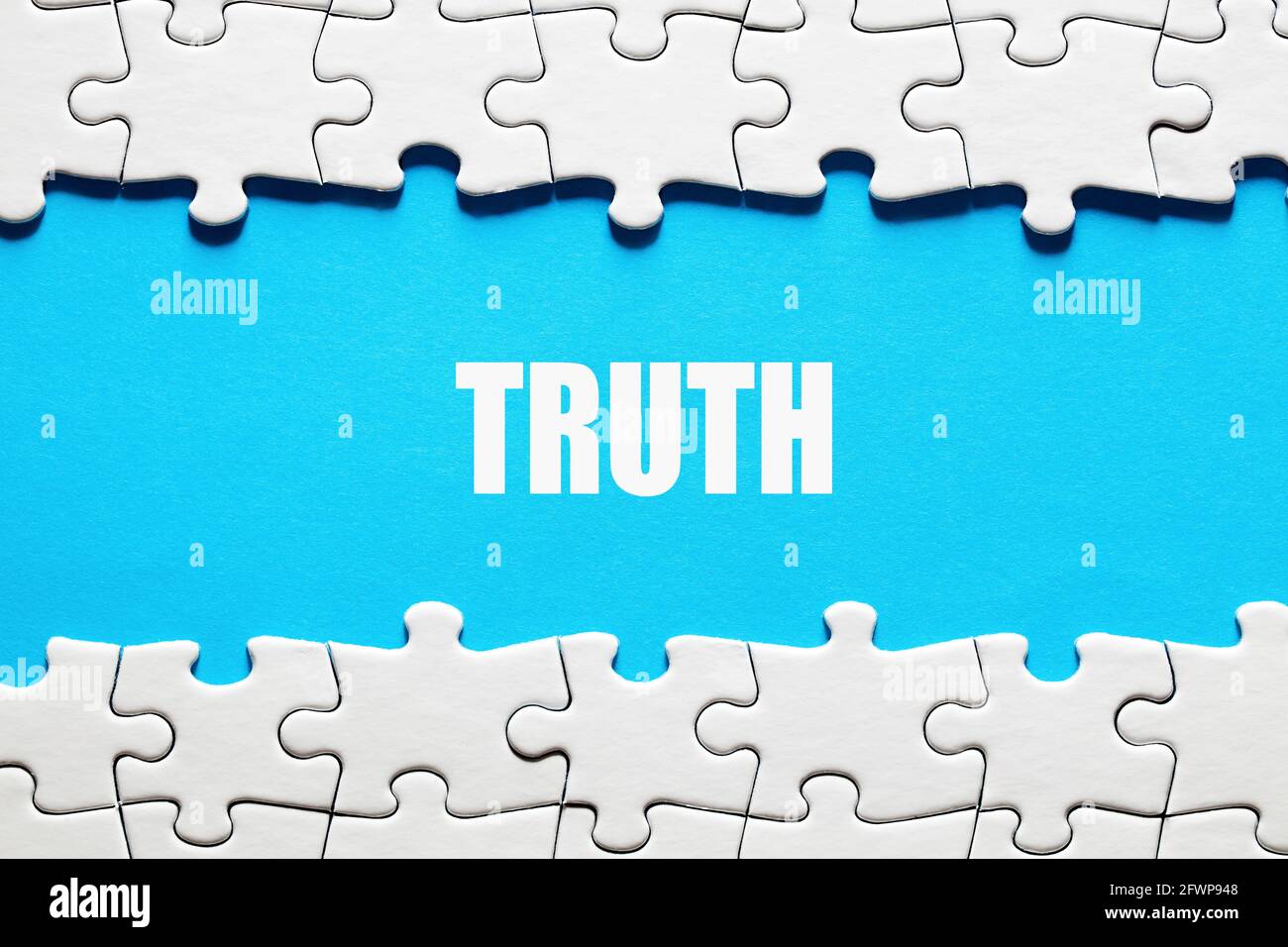 The word truth on blue background framed by jigsaw puzzle pieces. To ...