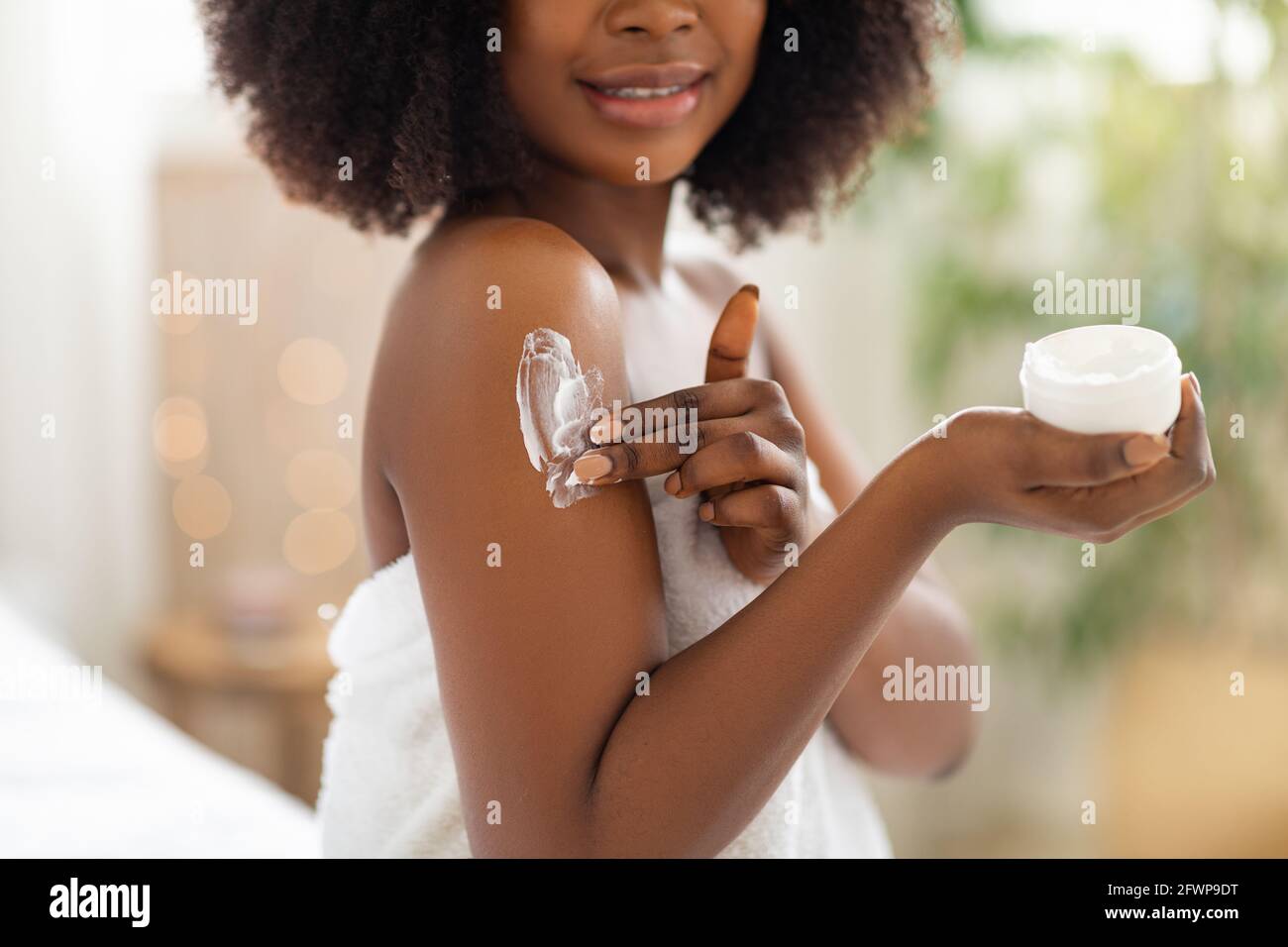 African american woman applying lotion hi-res stock photography and images - Alamy