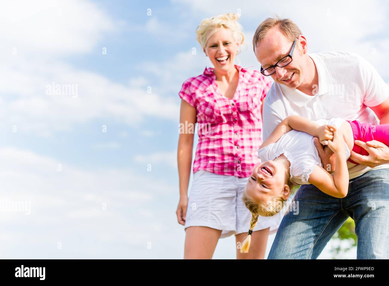 Family romping on field hi-res stock photography and images - Alamy