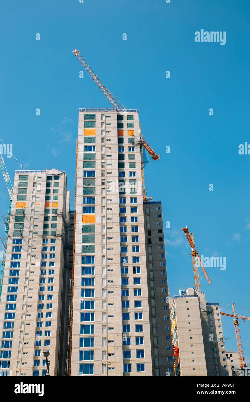 Modern apartment building with crane on construction site Stock Photo ...