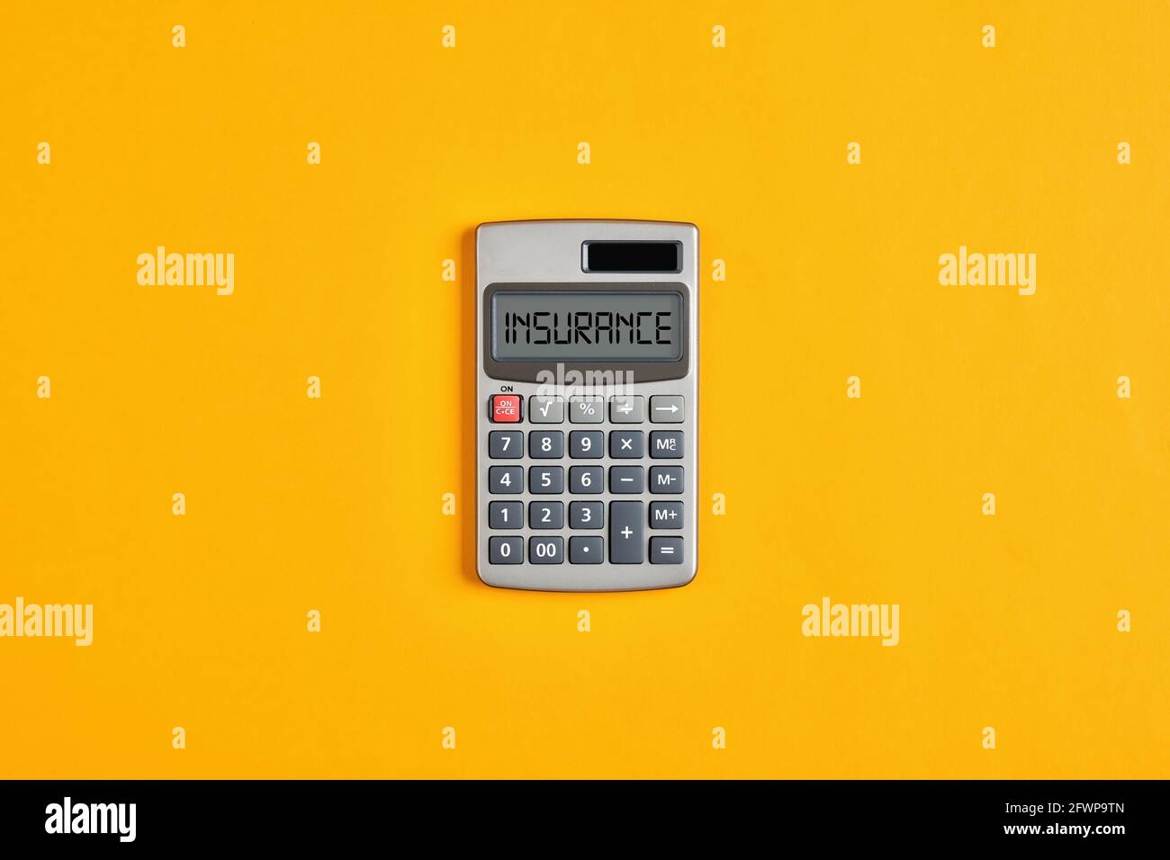 The word insurance on calculator display with yellow background ...