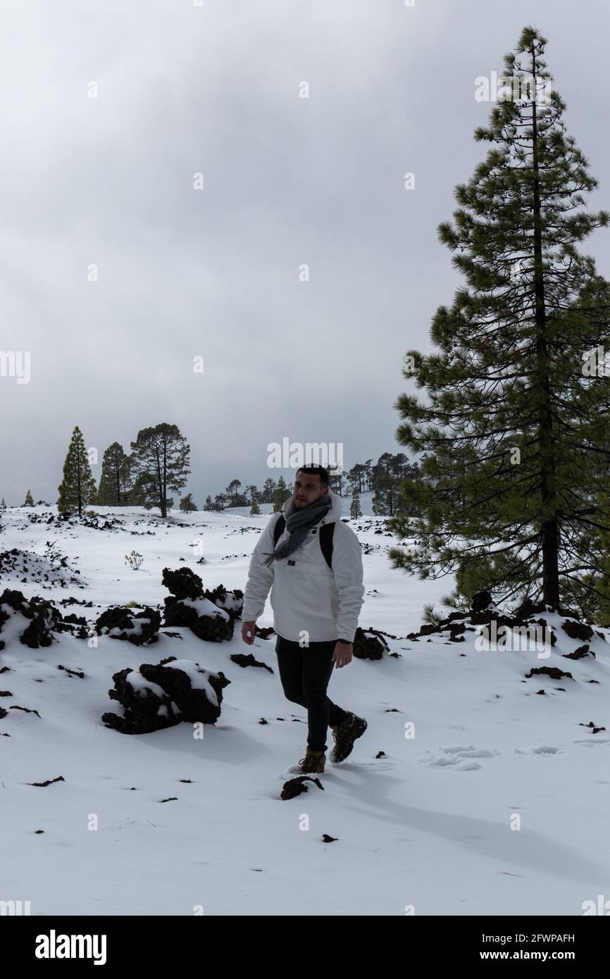 young boy in white jacket and backpack in snow Stock Photo - Alamy