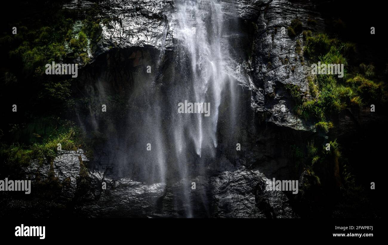 Stream of fresh water pouring down through the rocks in a tropical ...